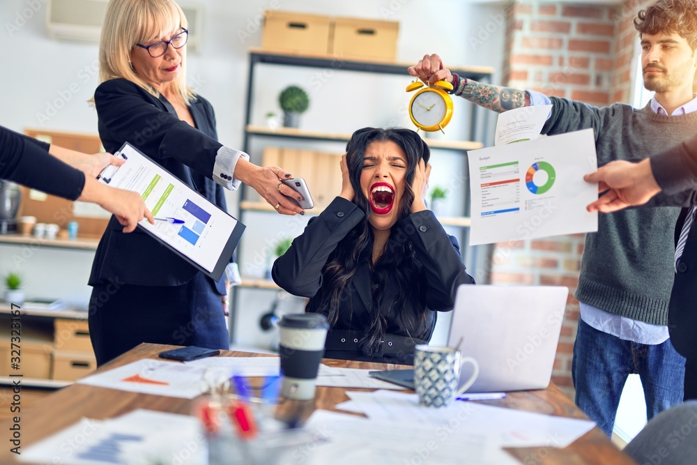 Group of business workers working together. Partners stressing one of ...