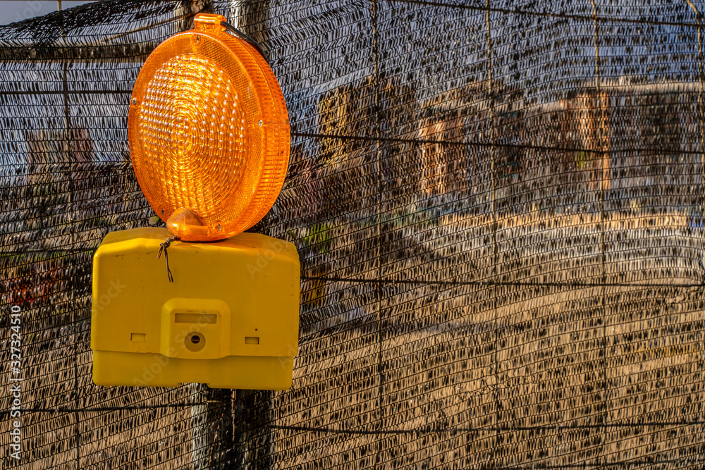 Warning light on a construction fence with copy space Stock Photo ...
