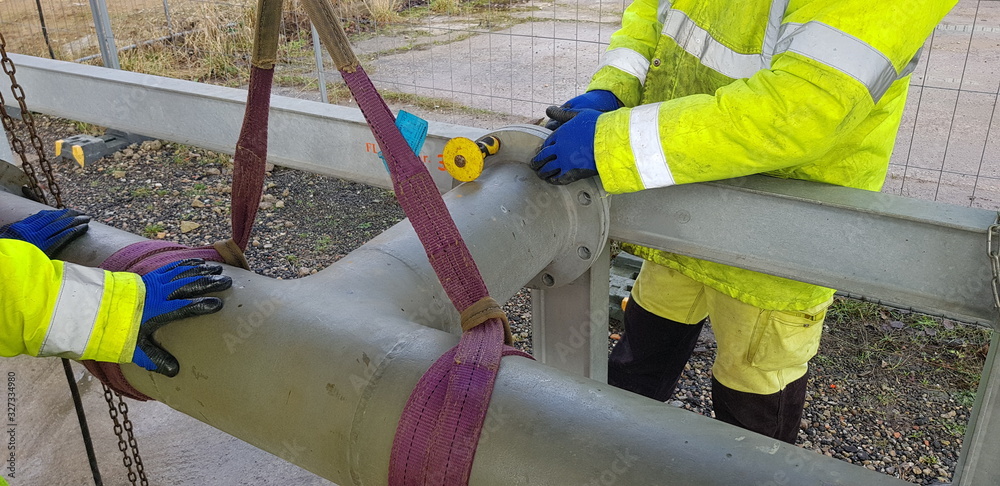 riggers move the pipe with two chain blocks and attach the flange with ...
