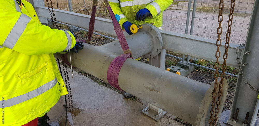 riggers move the pipe with two chain blocks and attach the flange with ...