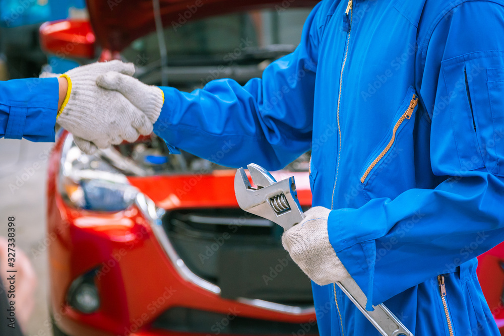 Mechanics shaking hands. Team work concepts Stock Photo | Adobe Stock