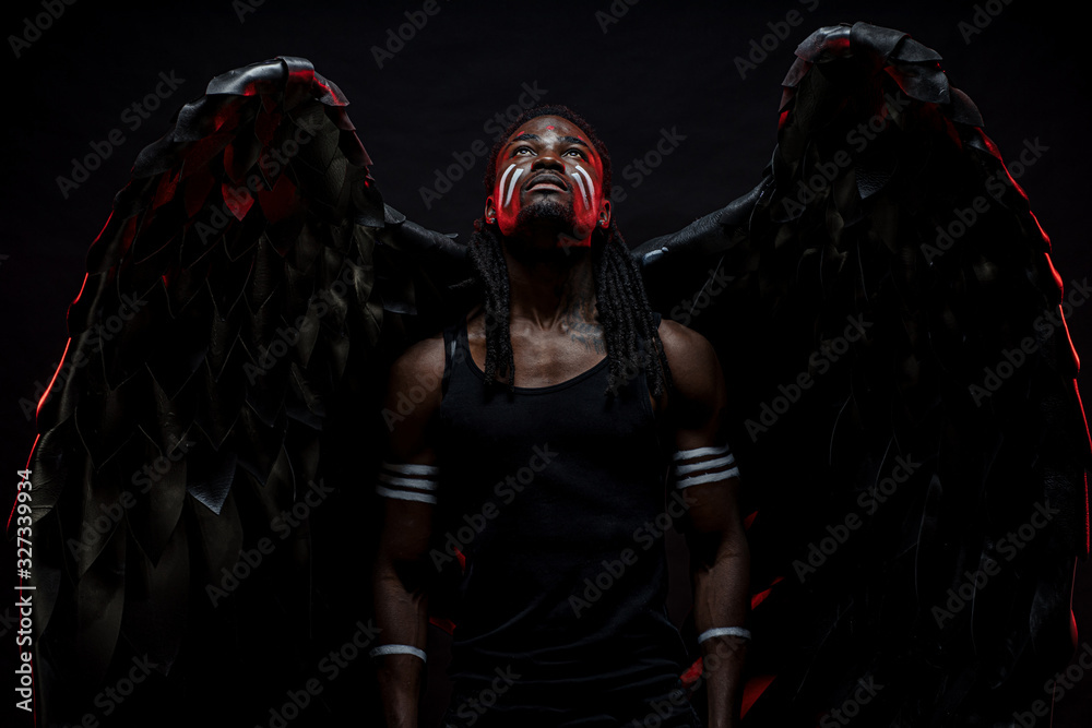 young strong black angel with cool wings, stand posing at camera. man ...