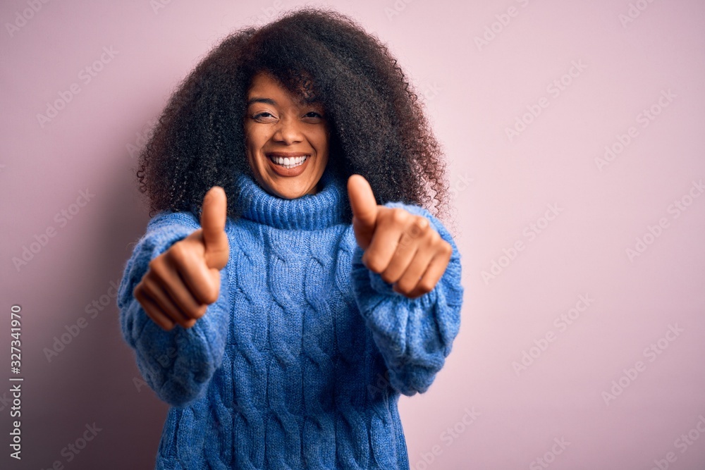 Young beautiful african american woman with afro hair wearing winter ...