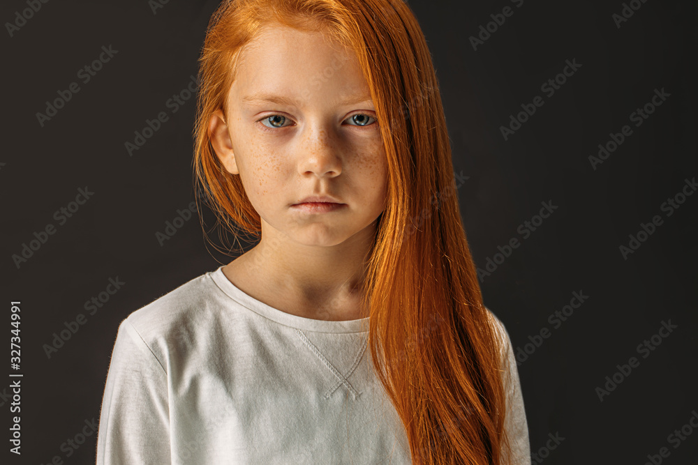 portrait of beautiful, serious redhaired caucasian girl isolated over ...
