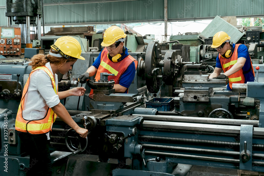 Engineer with Female mechanical worker with yellow safety helmet ...