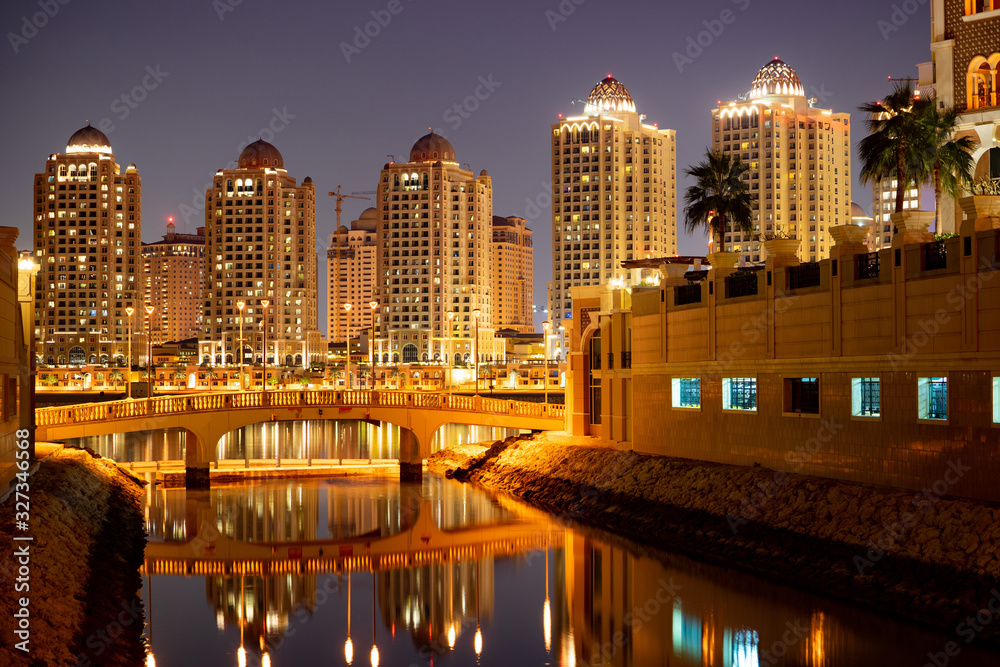 The Pearl-Qatar area buildings with bridge and water in Doha, Qatar ...
