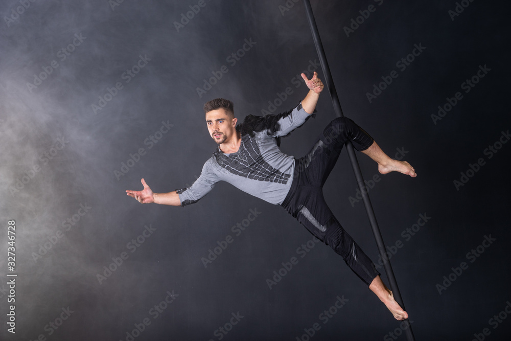 Performance concept. Man hanging on chinese pole. Athlete performing ...