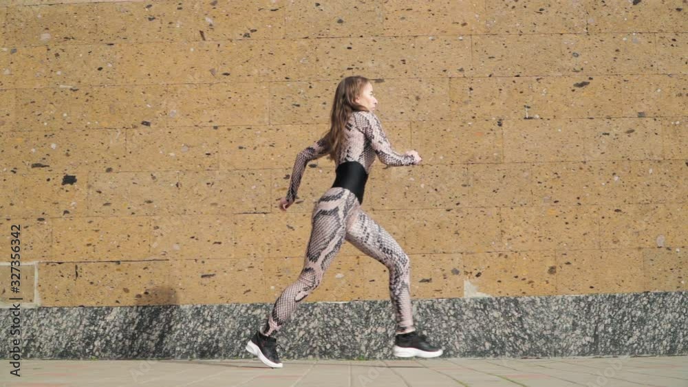 Young Beautiful Athletic Girl Gymnast with Steep Stretch. She makes a ...