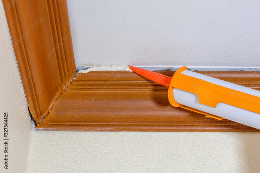 Technician man hand using glue gun or manual caulking gun with ...