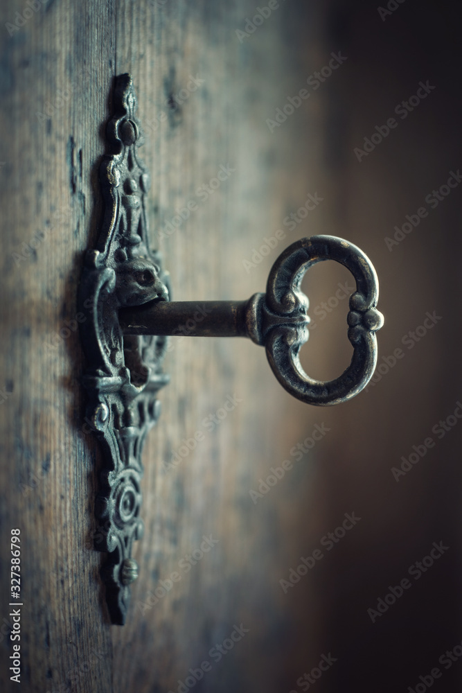 Old key in keyhole, macro shot. Gothic style. Key to knowledge. Concept ...
