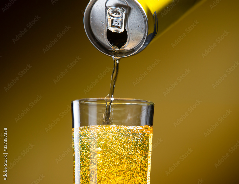 Carbonated energy drink pouring from an aluminum can into a glass Stock ...
