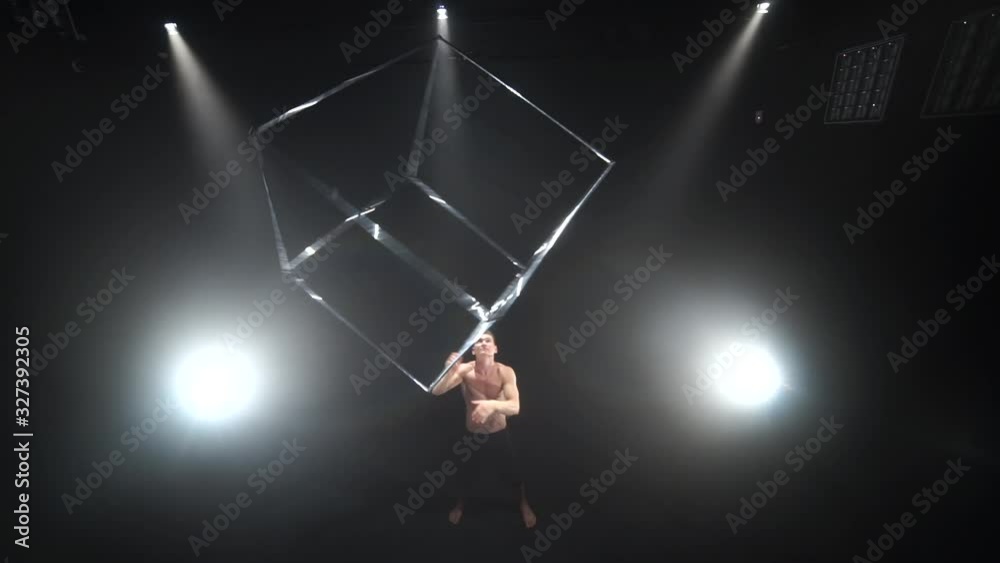 circus male muscular performer making tricks with juggling cube props ...