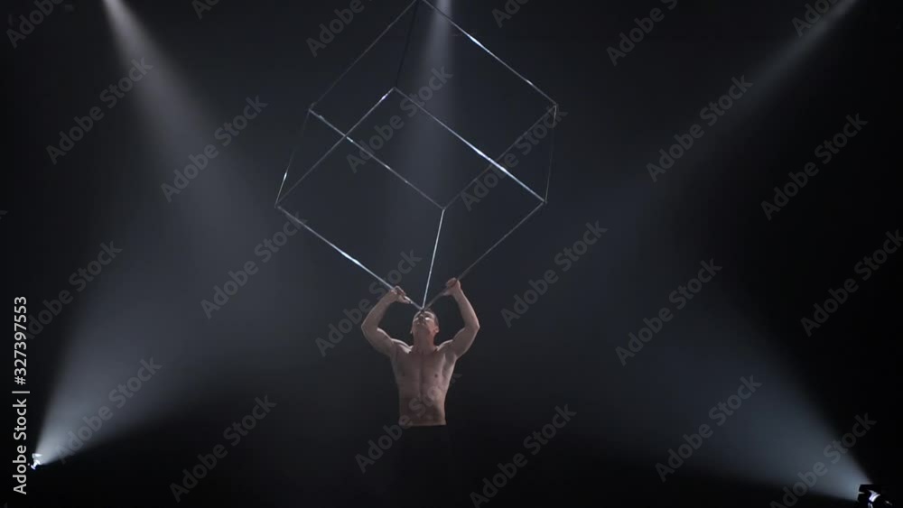 circus male muscular performer making tricks with juggling cube props ...