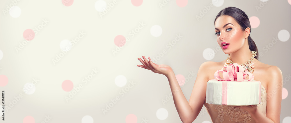 Beauty fashion model girl holding Beautiful Big Cake with sweet cream ...