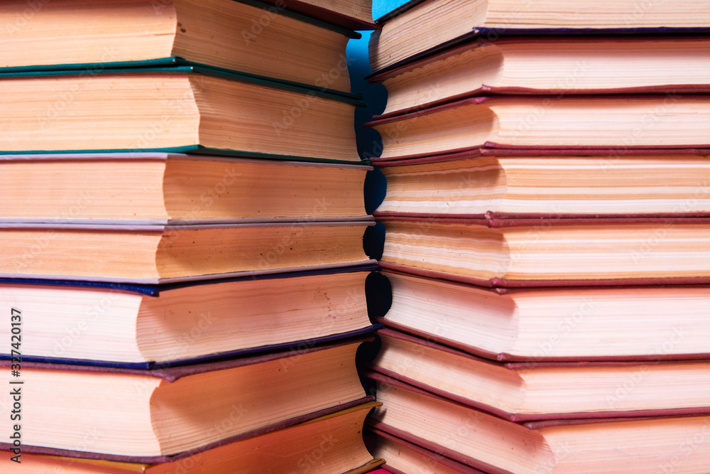 Two piles of books standing side by side. Stock Photo | Adobe Stock