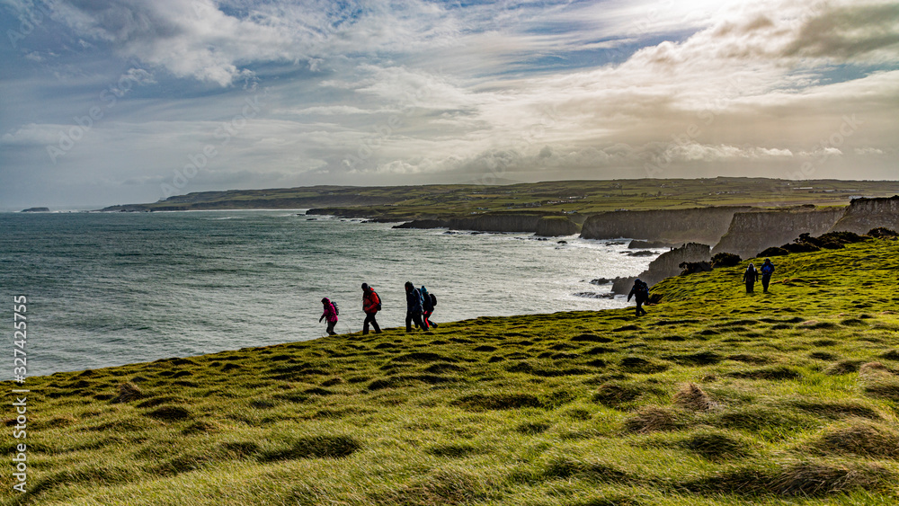 Hikers walking on the Causeway coastal way cliff path at Port Moon ...
