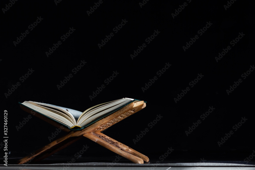 Quran in the mosque - open for prayers The black background of the ...