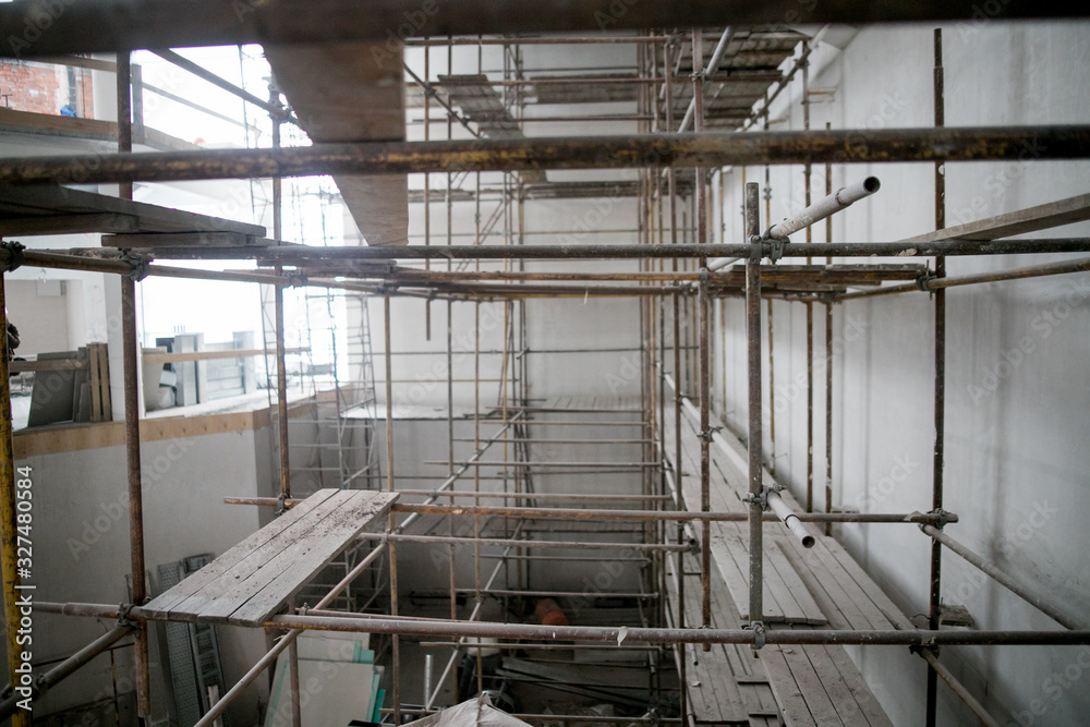 Scaffolding and wall plastering in buildings are under construction ...