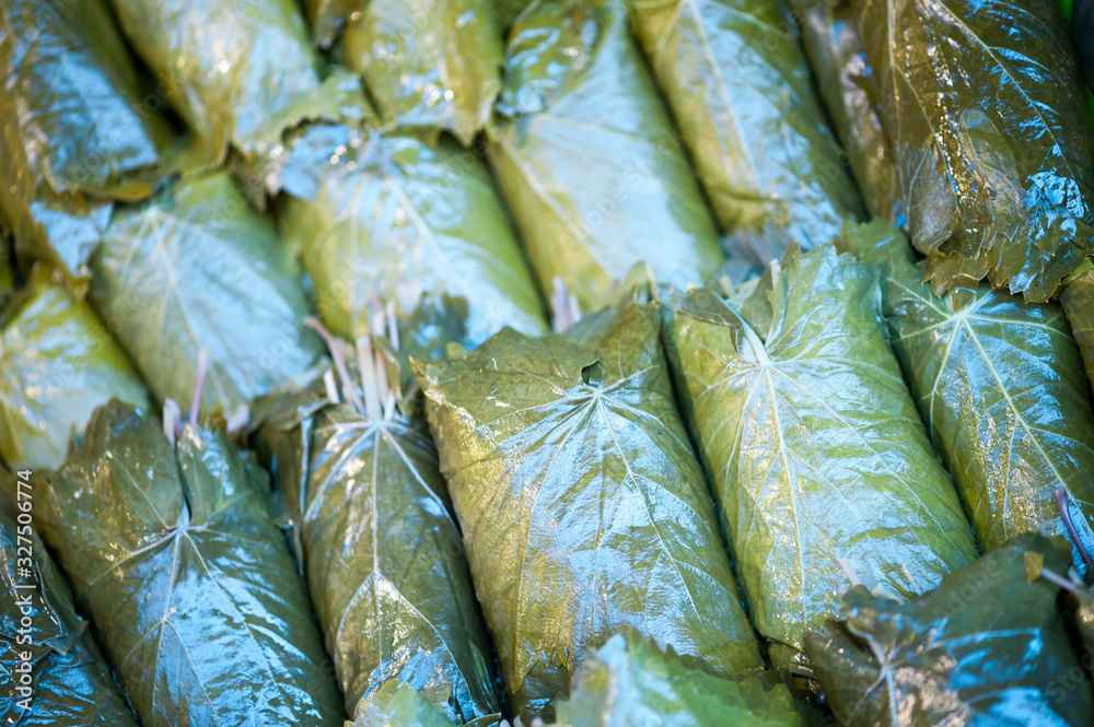 Stack of authentic Mediterranean stuffed grape vine leaves at an ...