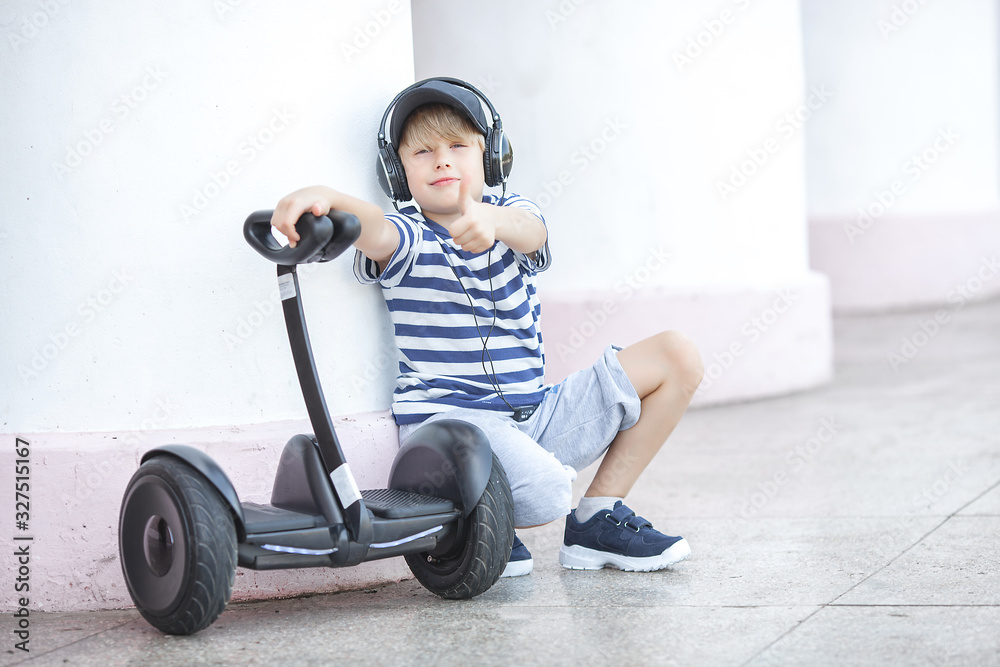 Cute child driving electric gadget. Boy riding a segway. Active child ...