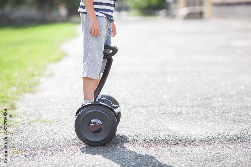 Cute child driving electric gadget. Boy riding a segway. Active child ...