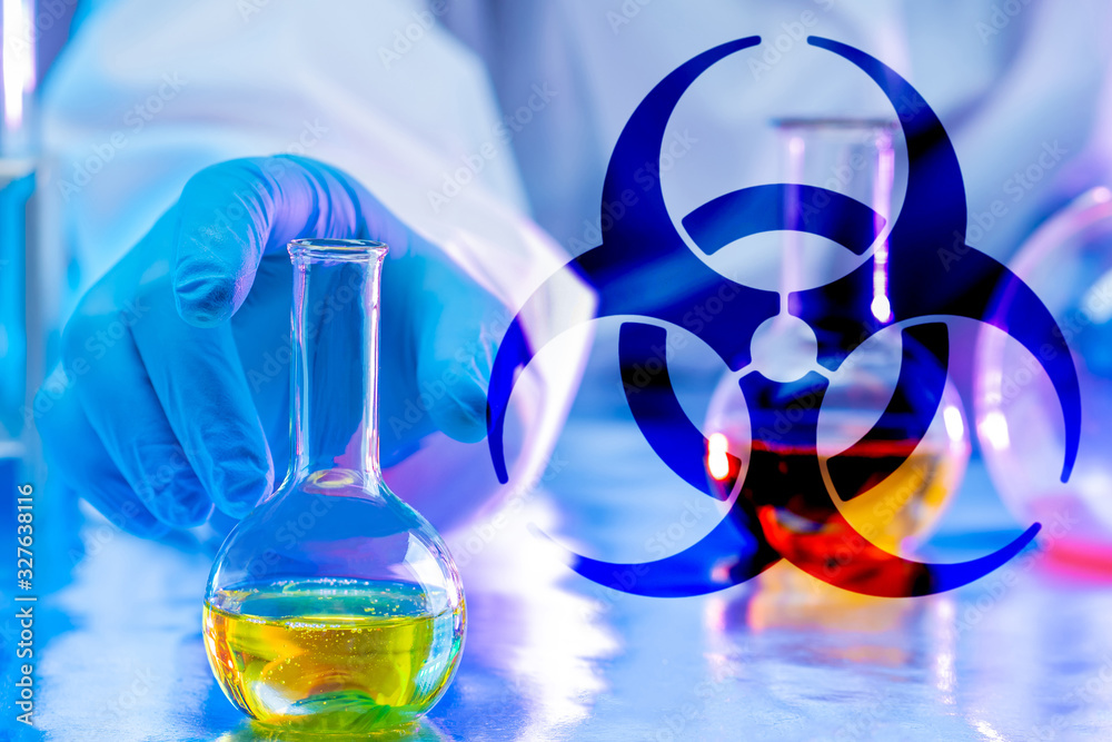 Biohazard. A rubber-gloved hand, a flask of yellow chemical liquid, and ...