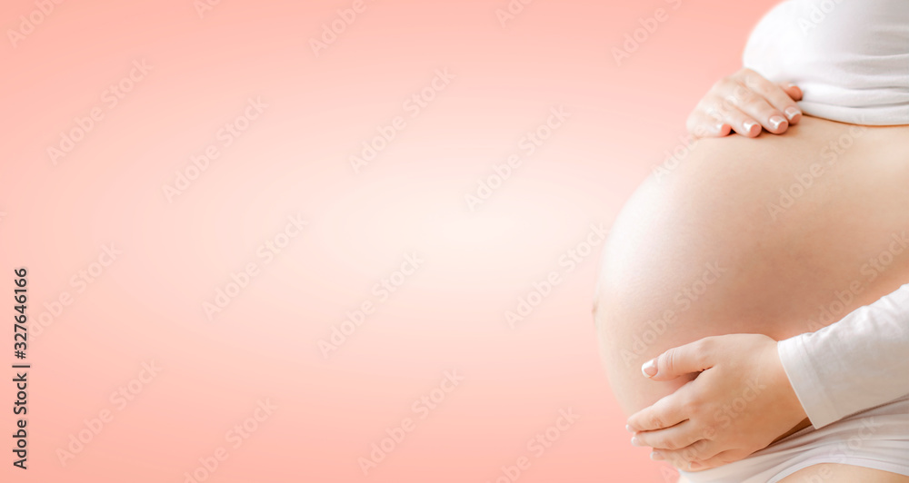 Pregnant woman belly detail isolated on pink Background. Pregnancy ...