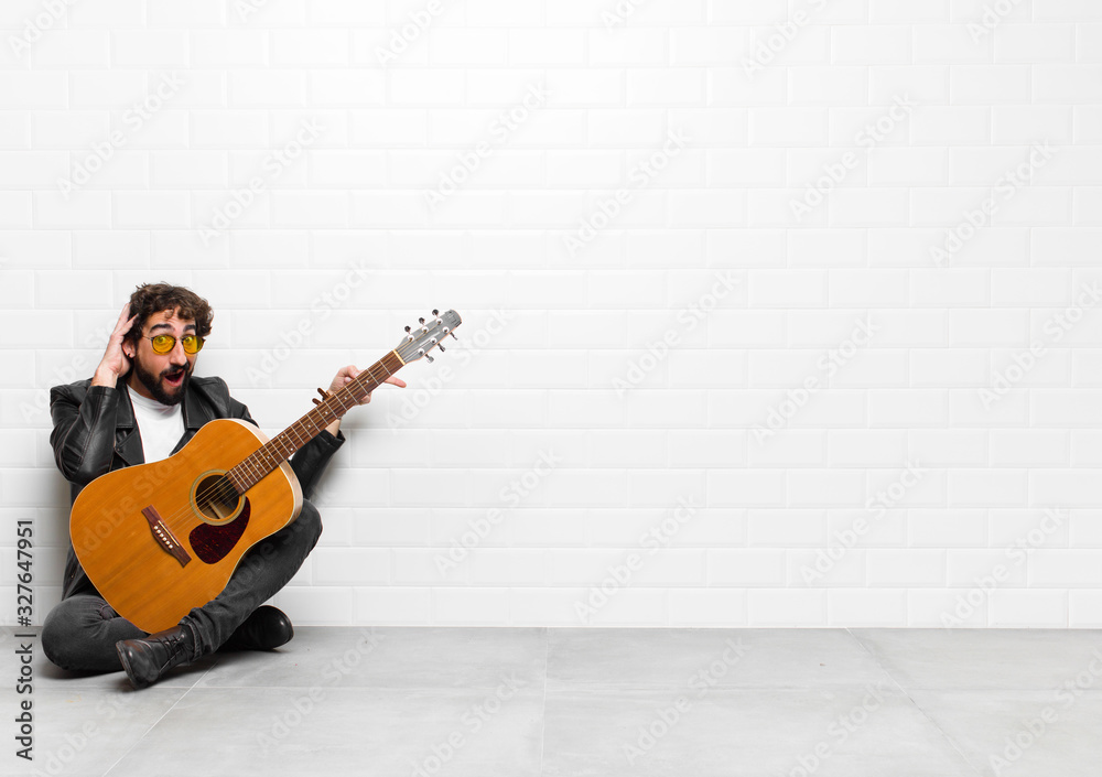 young musician man laughing, looking happy, positive and surprised ...