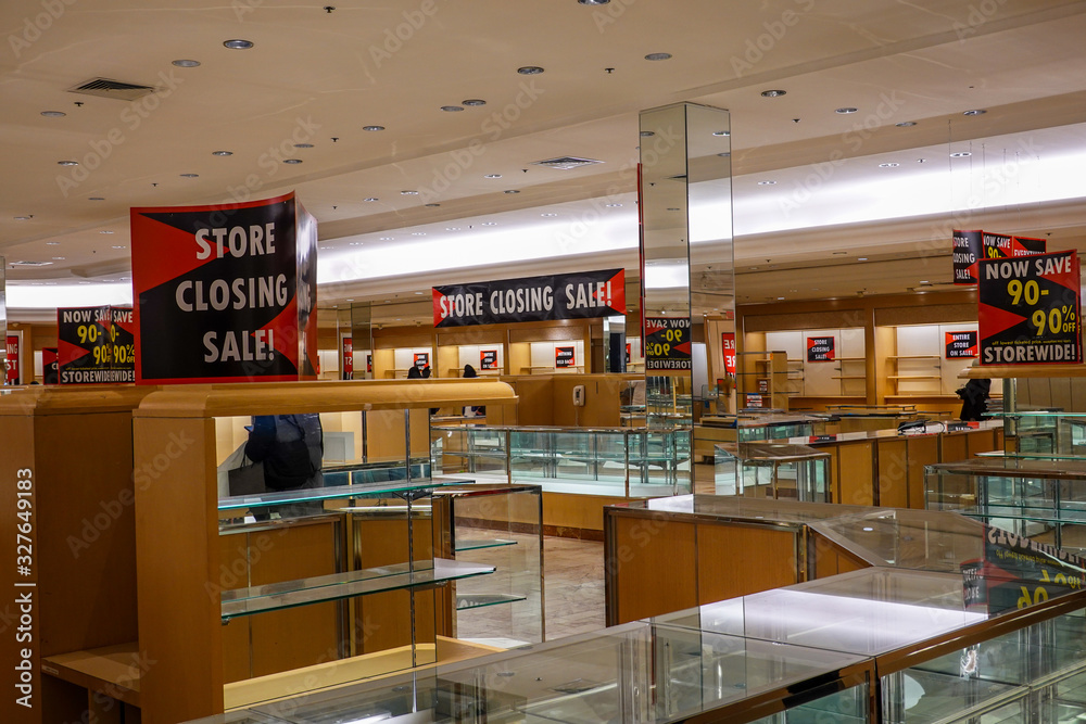 Sign for a store closing sale on top of an empty jewelry display case ...