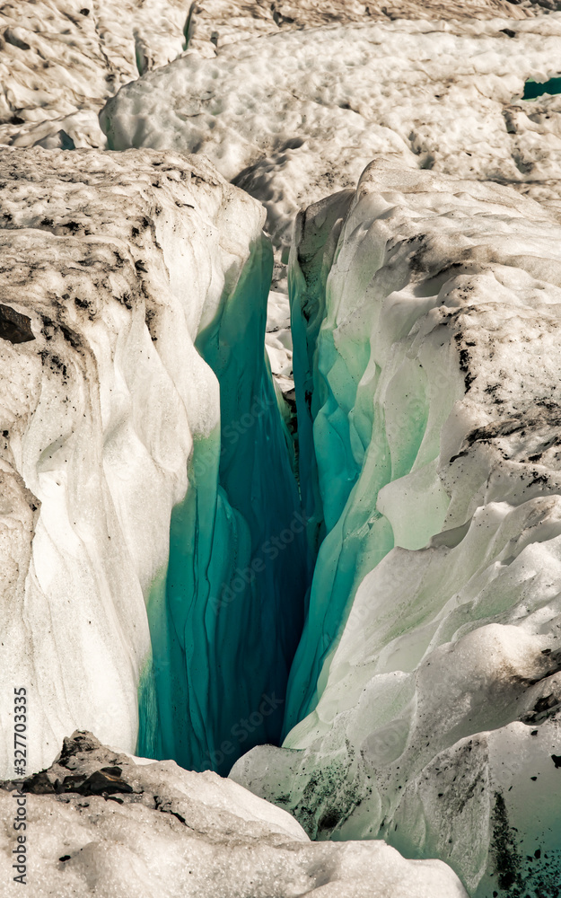 Brilliant blue colours of the inside of the deep crevice while hiking ...