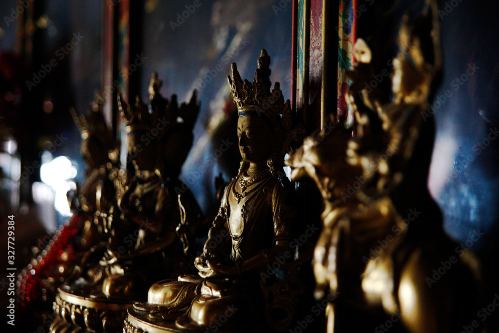 Buddhist ritual statues in temple of monastery. Dark interior of ...