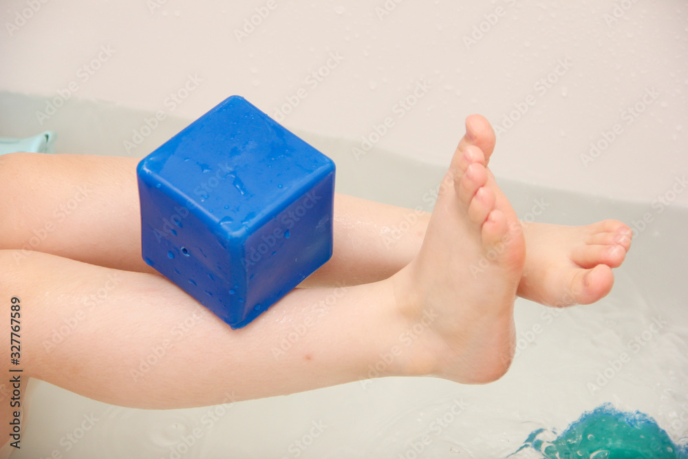 A little girl of two years is washing in the bath. child's body hygiene ...