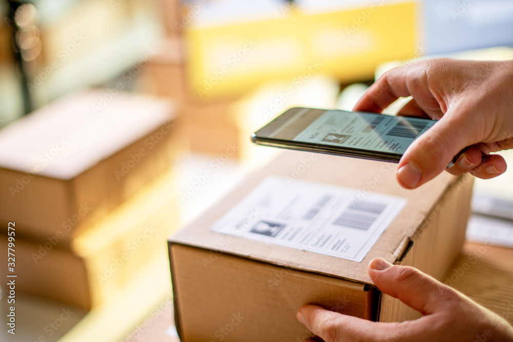 Delivery service, scanning a shipping label Stock Photo | Adobe Stock