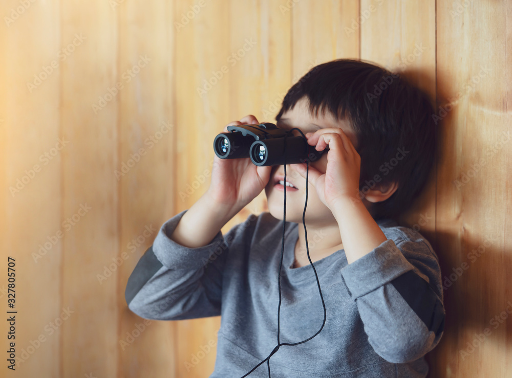 Portrait of kid boy child looking through of binoculars in the animals ...