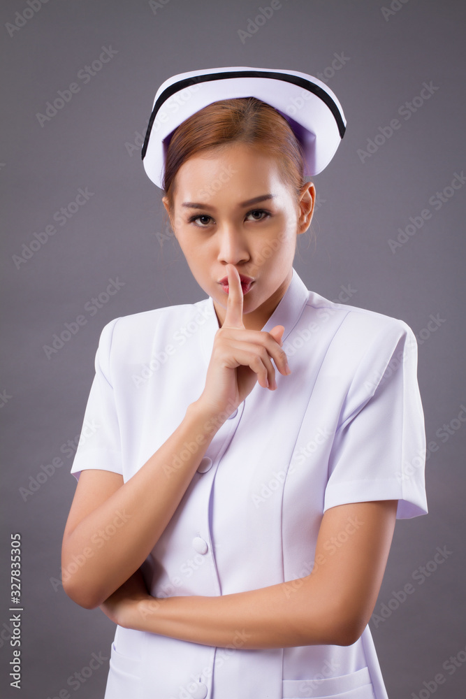 female nurse asking for silence, portrait of asian woman nurse with ...