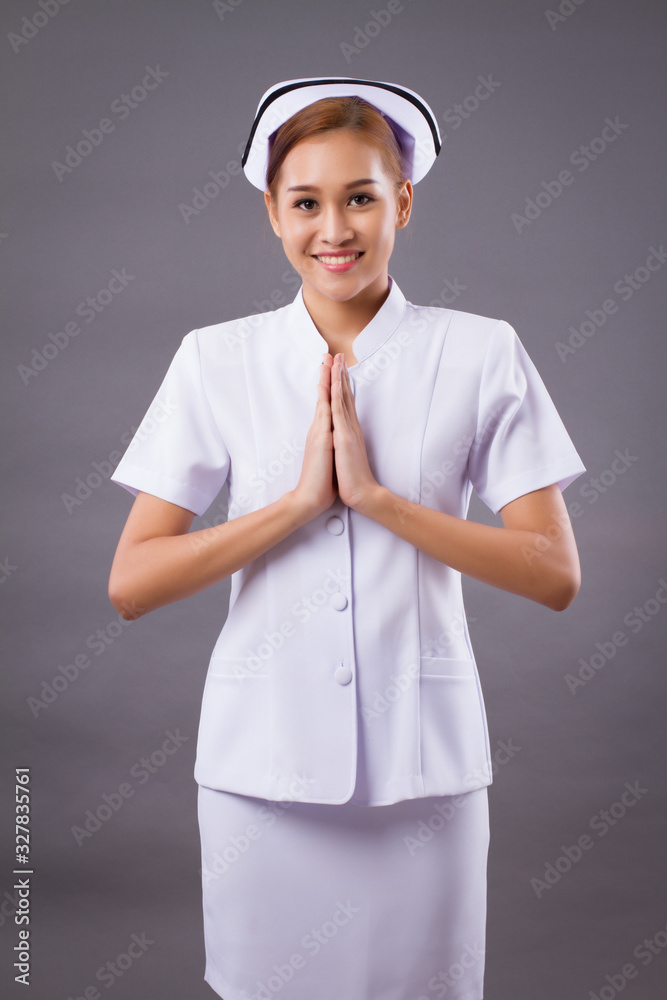 welcoming nurse with asian sawasdee or namaste greeting gesture ...