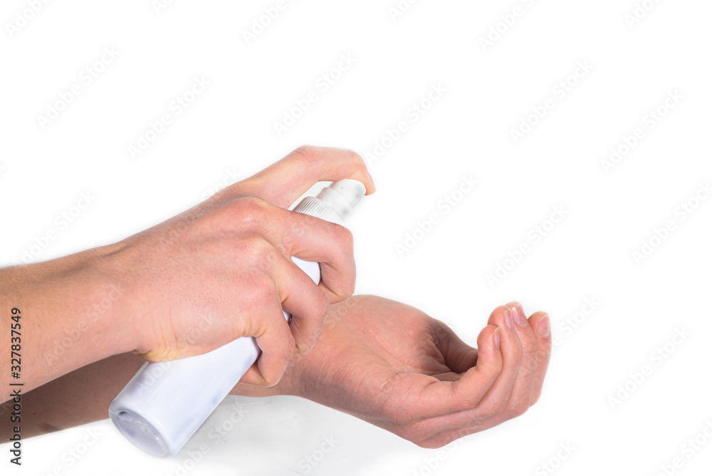 Hand hygiene. Hands hold a bottle of disinfectant spray and spray ...