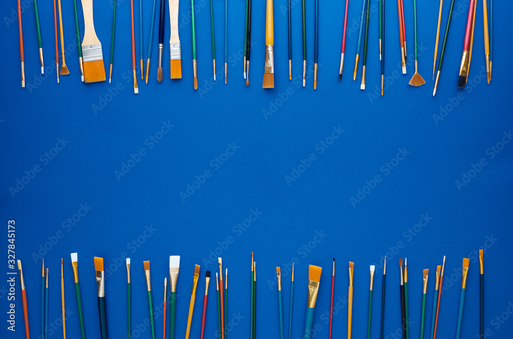 Set of art paint brushes of various color, size and bristle type laid ...
