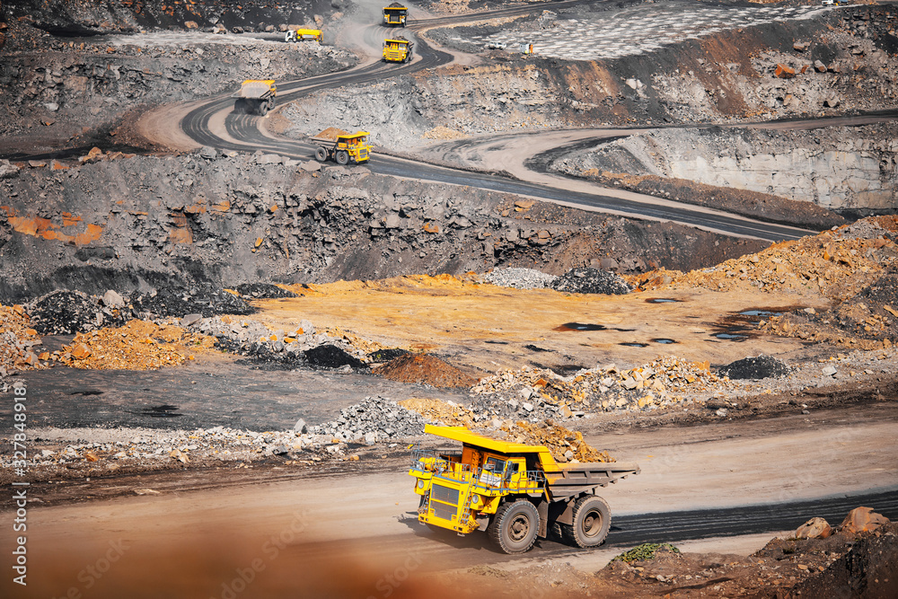 Big yellow mining truck transportation of gold ore. Open pit mine ...