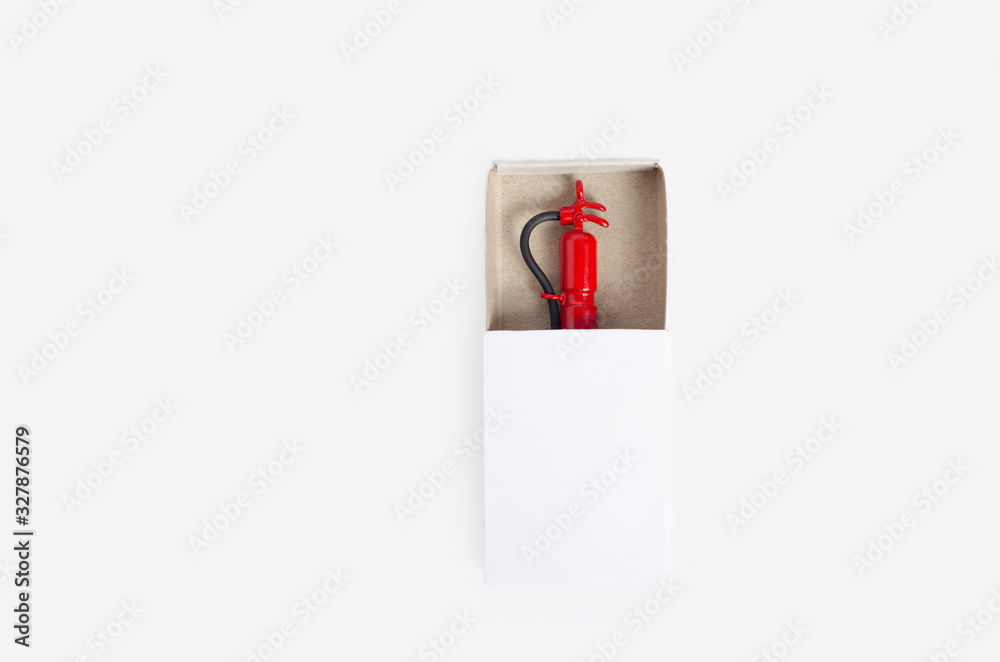 Tiny fire extinguisher inside a white match box, top view, isolated on ...
