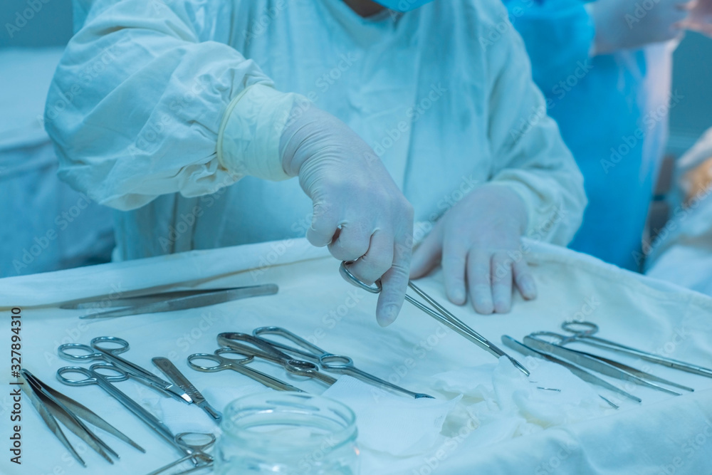 closeup, the hands of a nurses hand, an assistant surgeon takes a ...