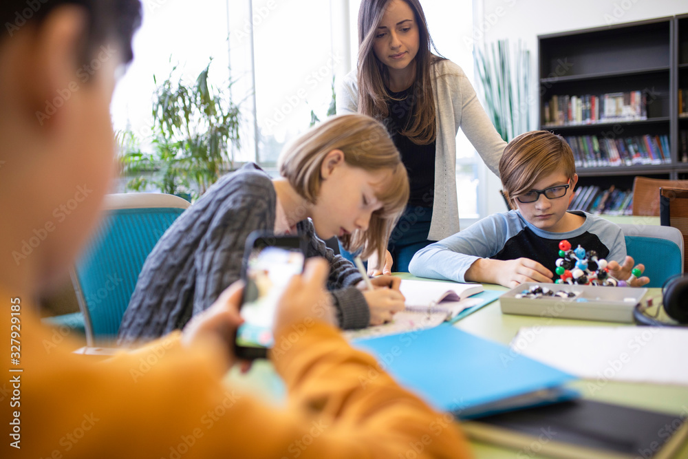 Junior high students studying in classroom Stock Photo | Adobe Stock