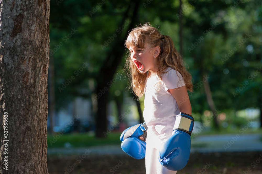 Angry little girl with boxing gloves Stock Photo | Adobe Stock