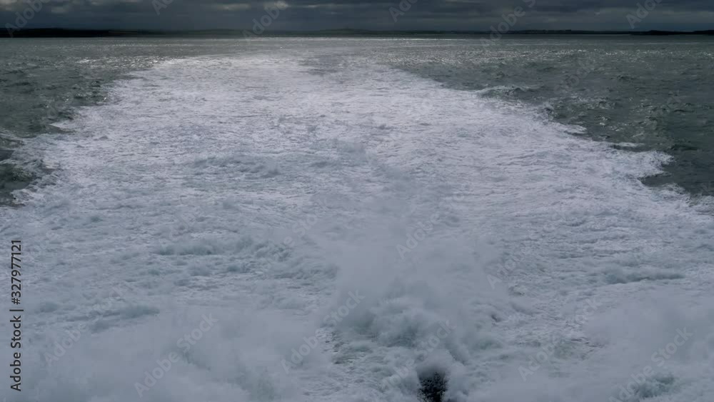 Turbulent water of sea wake left by jet engines of fast ferry. Stock ...