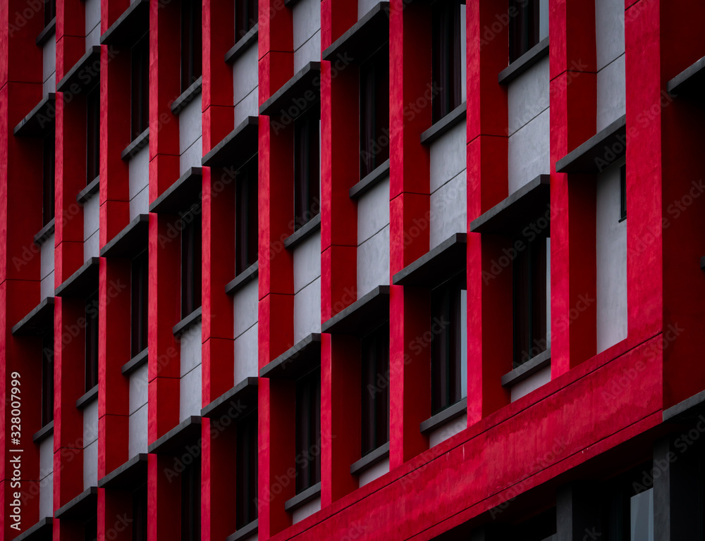 Glass window of skyscraper office building with red and white concrete ...