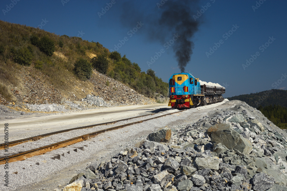 Diesel locomotive emitting a column of black smoke in a quarry for ...