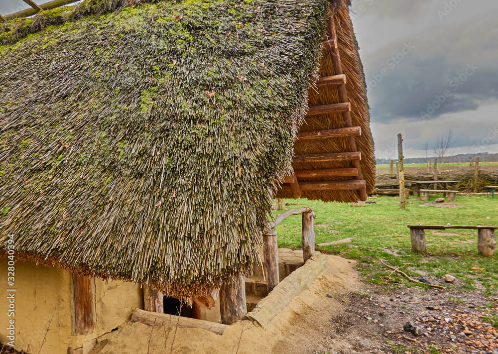 Historical traditional house with deep thatched roof, entrance from ...