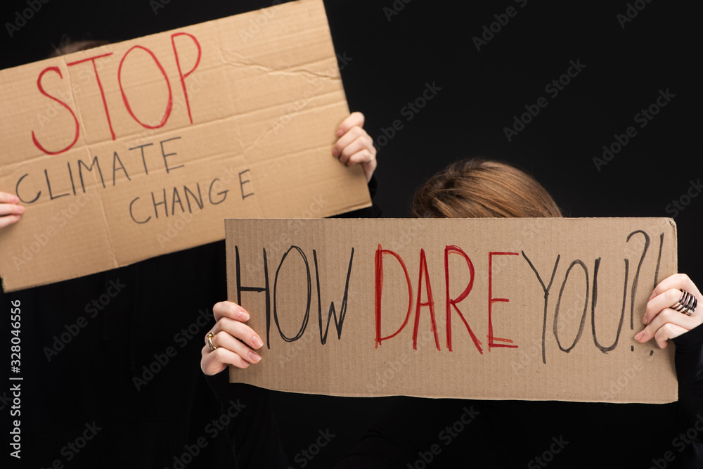 Partial view of women with placards with stop climate change and how ...