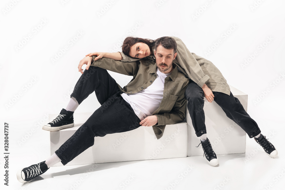 One whole. Trendy fashionable couple isolated on white studio ...