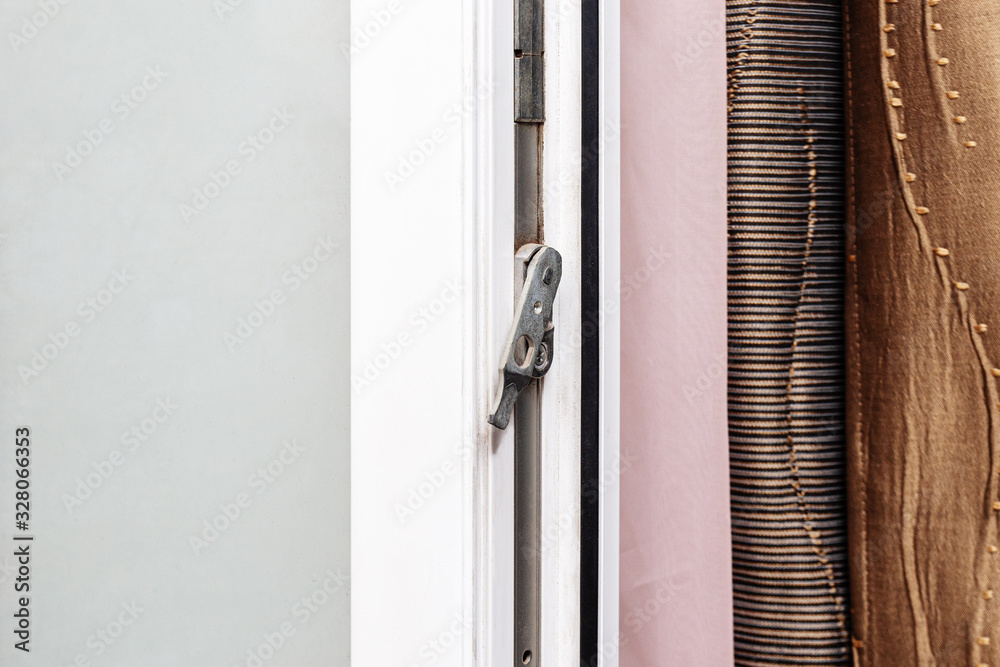Open plastic window in the house. The main mechanism of locking the ...